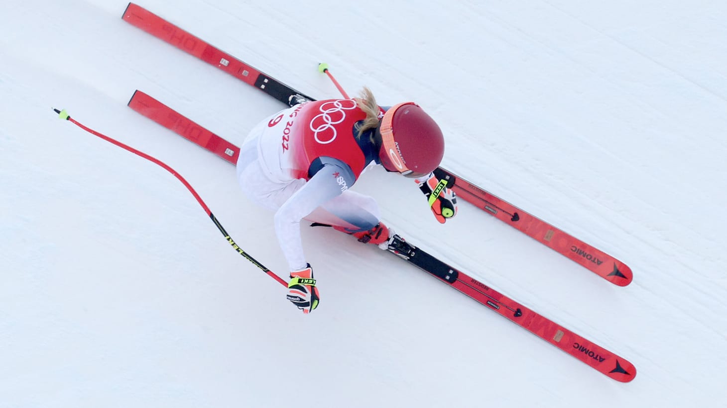 Why are alpine ski poles for speed disciplines curved?