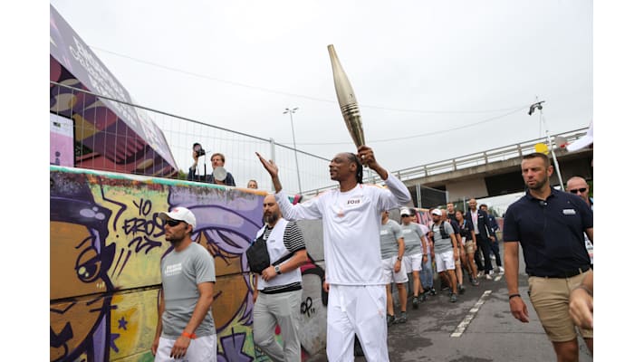 The Olympic torch blazes from Saint-Denis to Paris in a spectacular ...