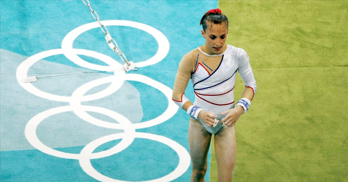 France compete on uneven bars during qualifying at the 2004 Olympic ...