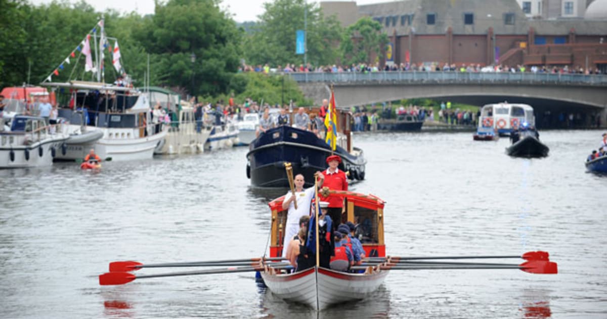 Olympic Flame takes to the water in rowing boat - Olympic News