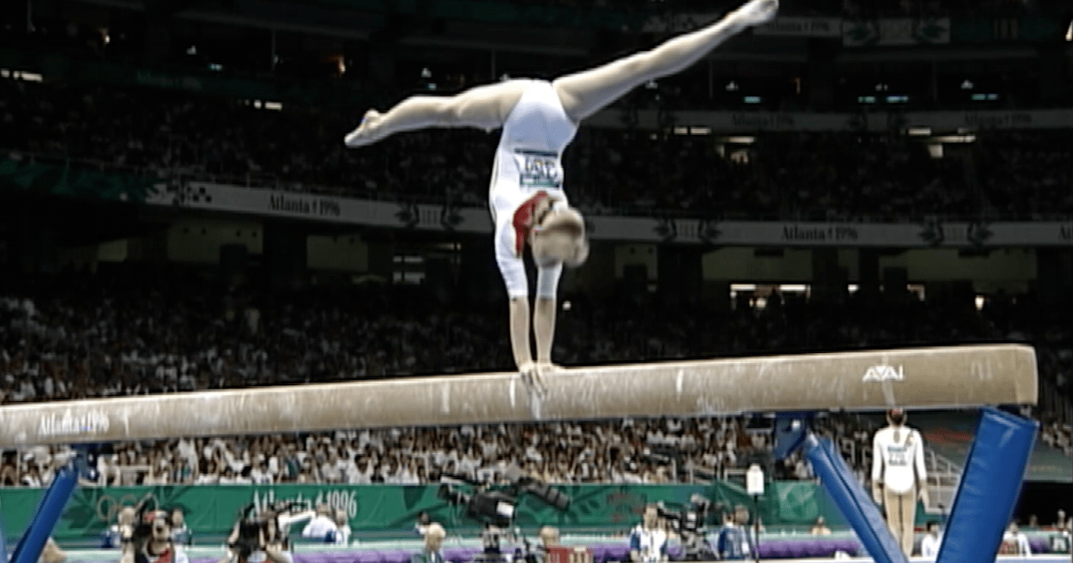 Team Romania performs their compulsory balance beam routines at Atlanta ...